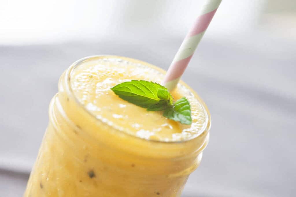Mango & Passion Fruit Tropical Smoothie - Vibrant plate Mango & Passion Fruit Tropical Smoothie - Vibrant plate